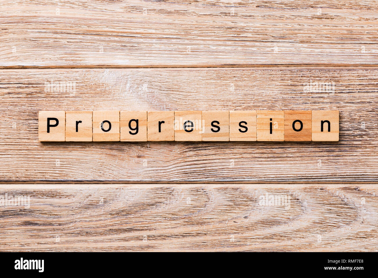 progression word written on wood block. progression text on wooden ...