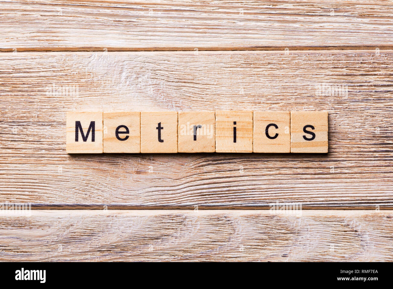 METRICS word written on wood block. METRICS text on wooden table for ...