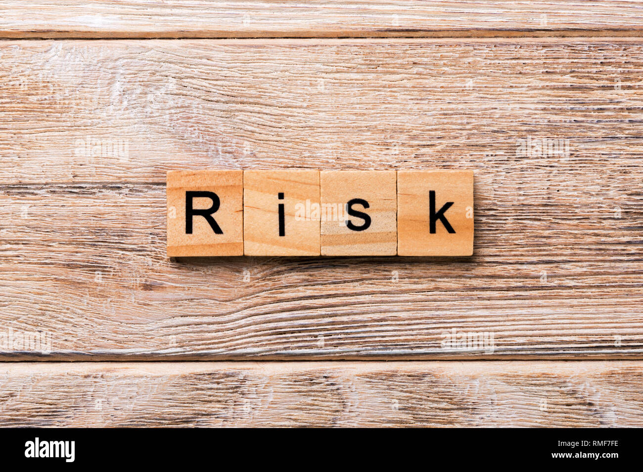 Risk word written on wood block. Risk text on wooden table for your ...