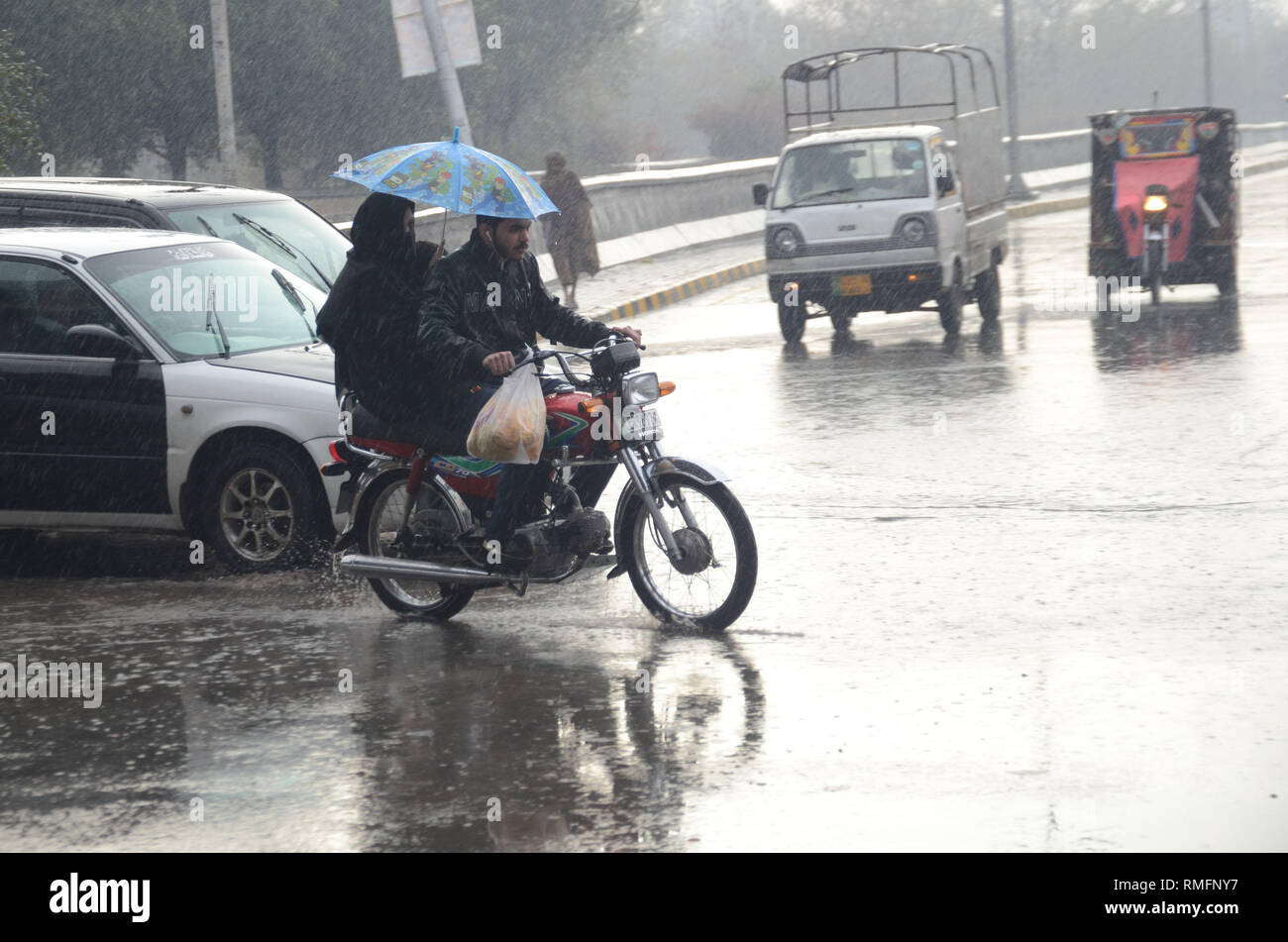 People and motorist on their way during fresh spell of heavy rain fall ...