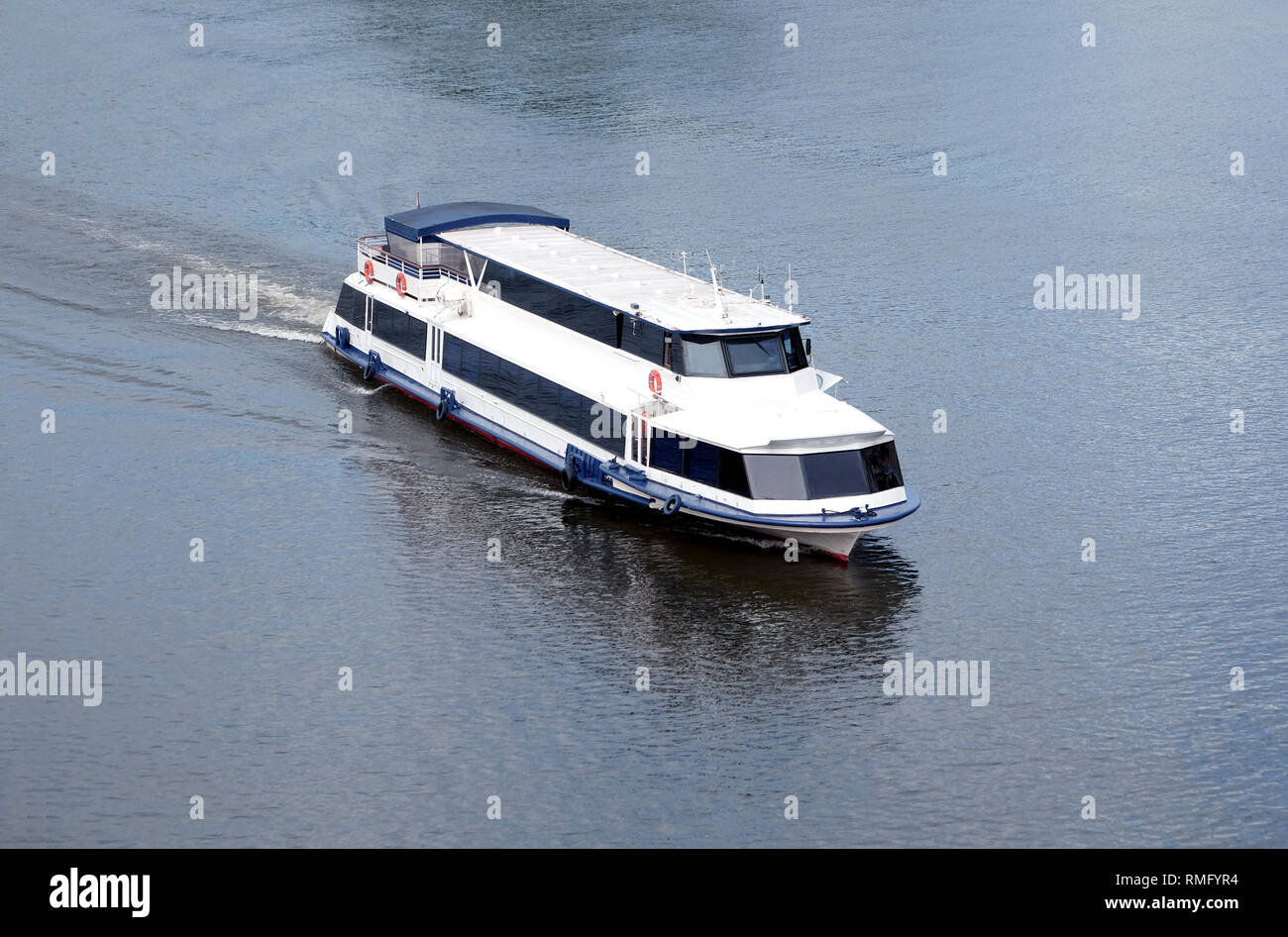 White passenger ship slow float sails on a river in summer day top view ...