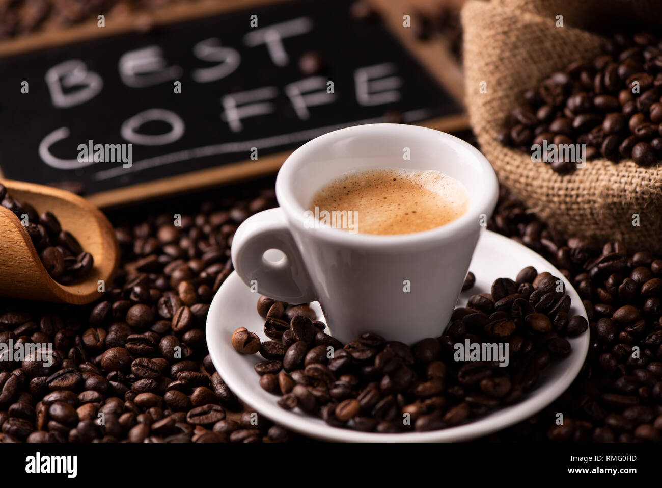 Expresso coffee cup close-up over dark roasted coffee beans Stock Photo ...