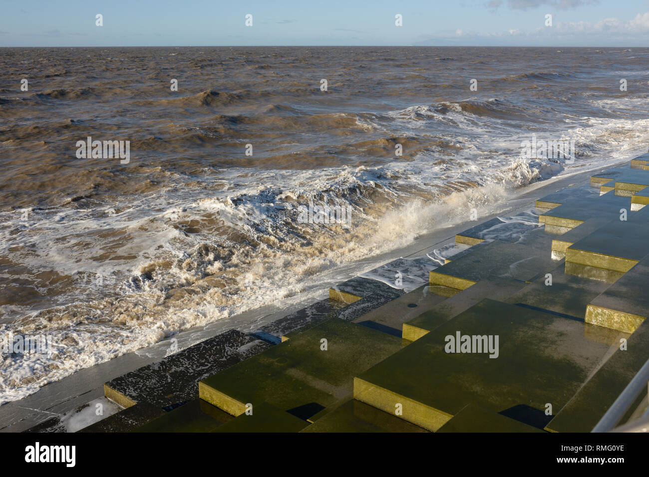 Wave breaking on sea wall in rough sea during stormy weather and high ...