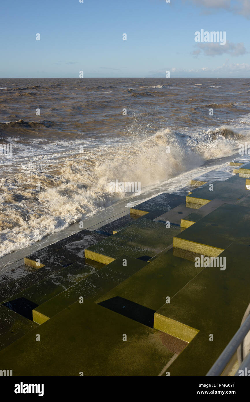 Wave breaking on sea wall in rough sea during stormy weather and high ...