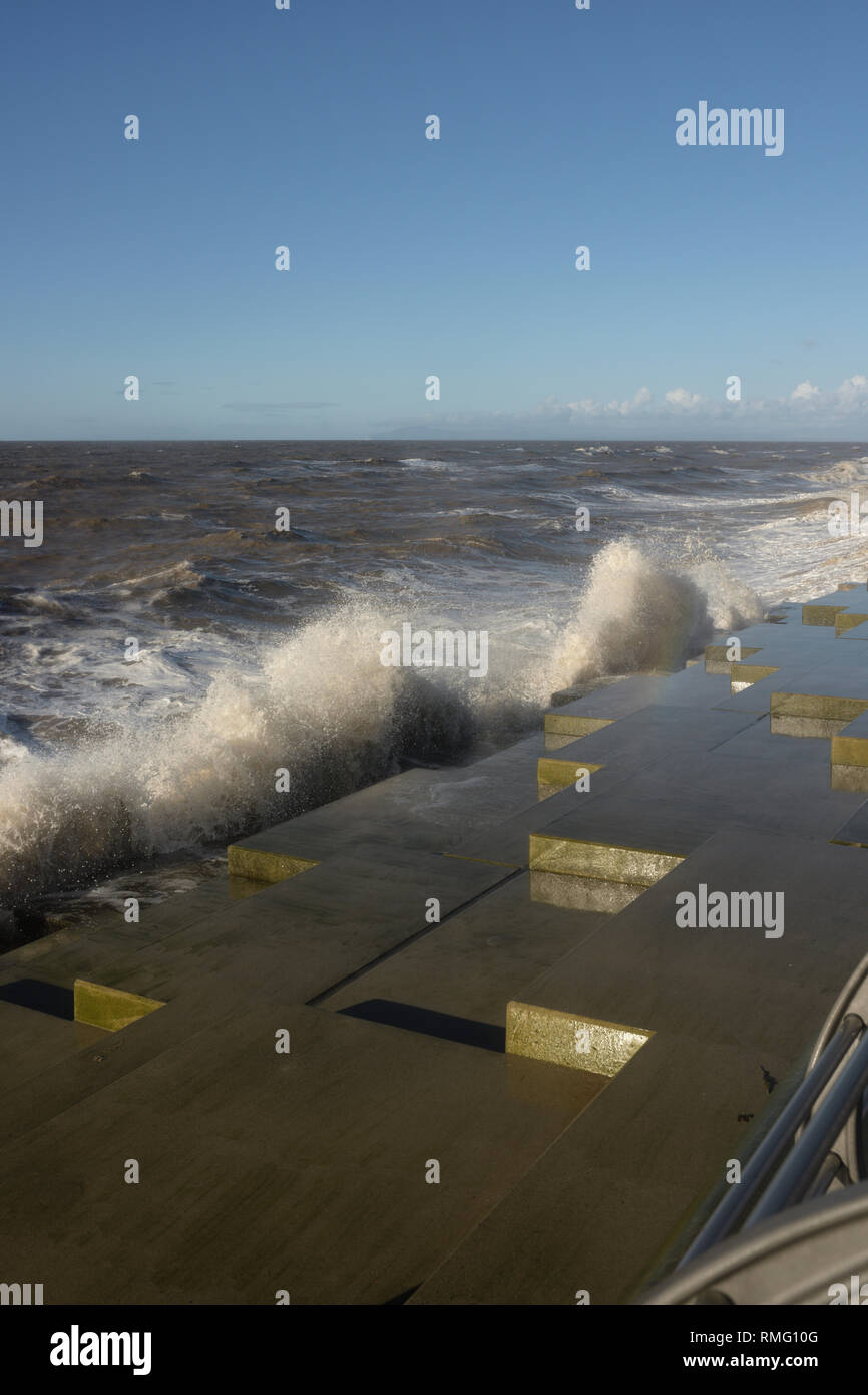 Wave overtopping concrete wavebreaker units in rough sea during stormy ...