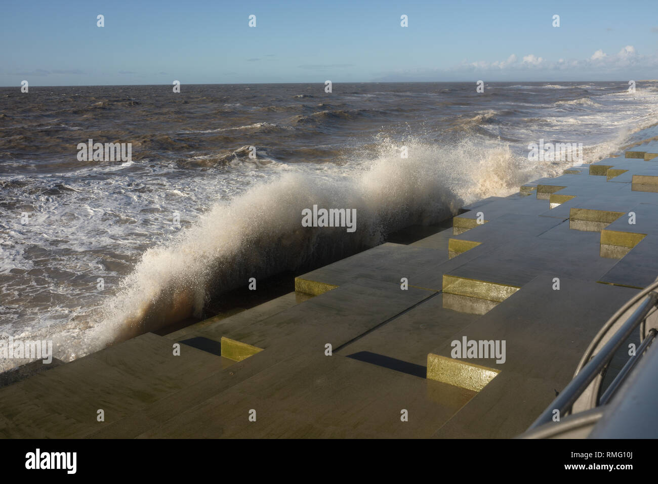 Wave overtopping concrete wavebreaker units in rough sea during stormy ...