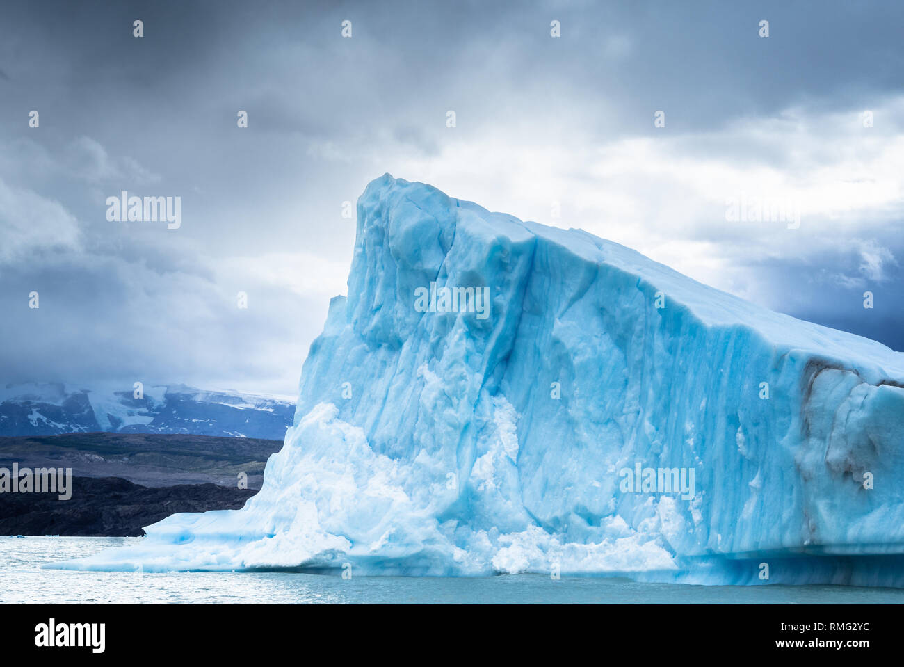 Fantastic view of huge cold iceberg against gray cloudy sky in ...