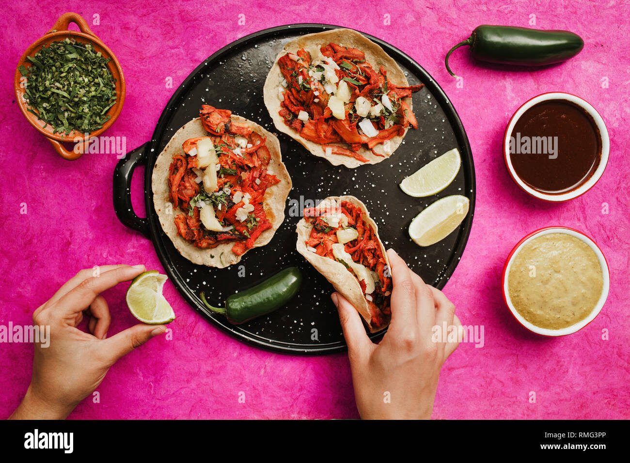 Crop hand holding taco al pastor Stock Photo - Alamy