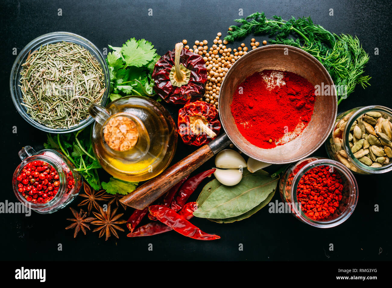 From above set of various spices and herbs placed on black background ...