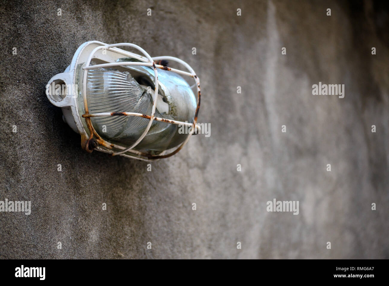 Old broken lamp on a wall Stock Photo - Alamy