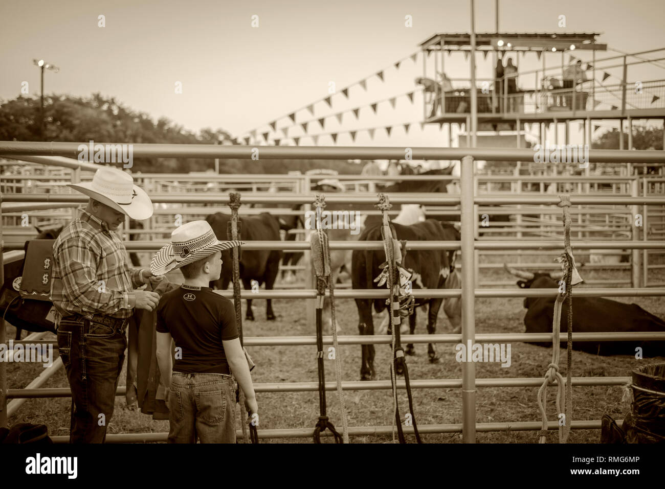 Father son talk at Texas rodeo Stock Photo - Alamy