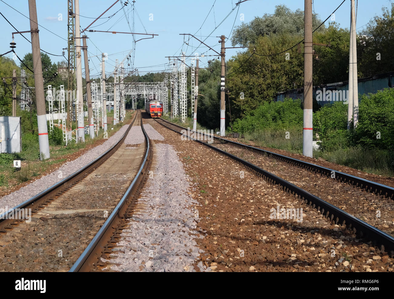 Industrial landscape with two way railroad track rails and red ...