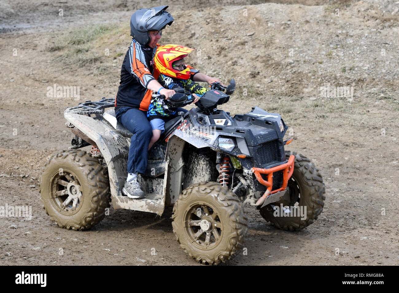 Father and son riding a quad/ATV offroad Stock Photo - Alamy