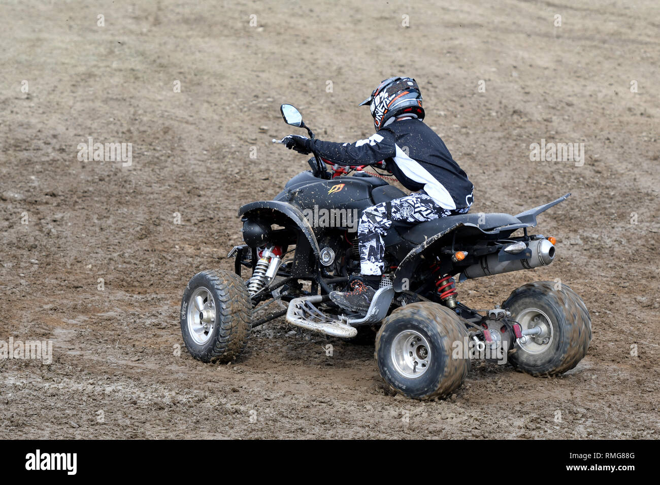 A young boy riding a quad/ATV offroad Stock Photo - Alamy