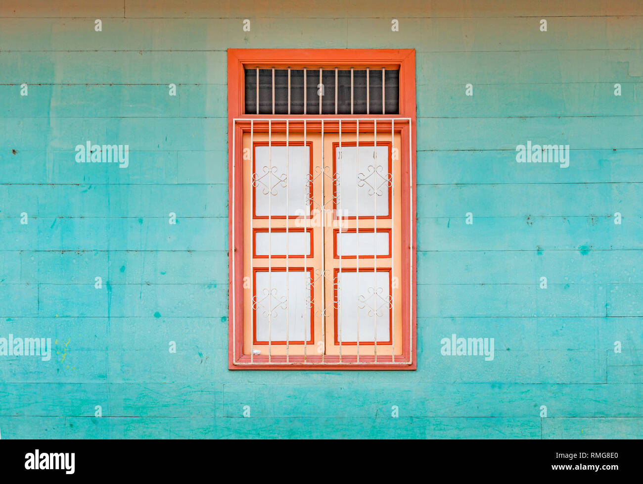 Architecture detail of a window with a wooden turquoise wall in the ...