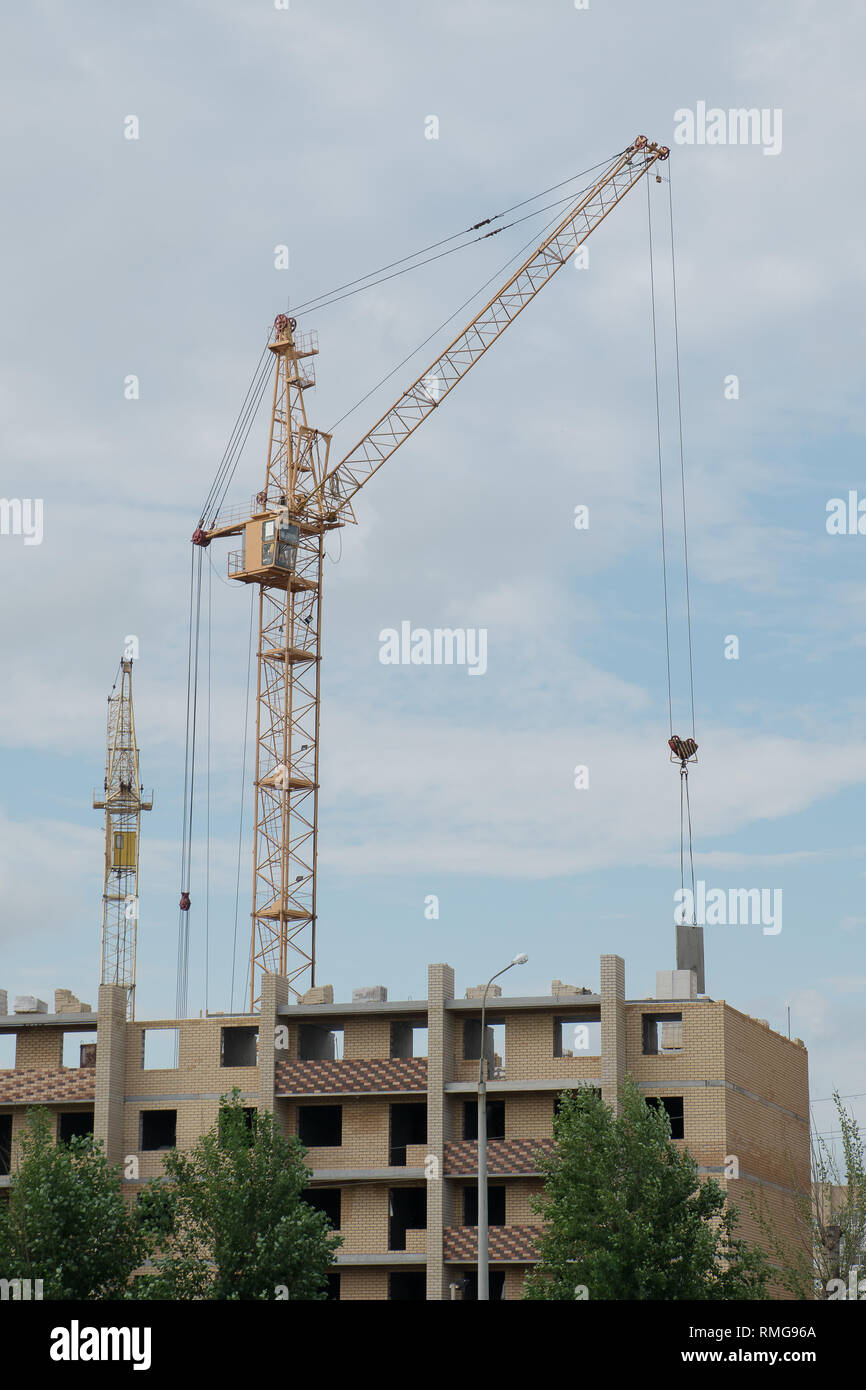 construction cranes in operation, a new building Stock Photo - Alamy