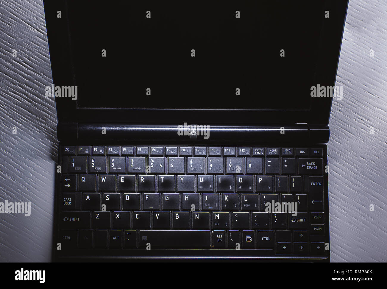 Details of a small, old and dusty laptop on white table Stock Photo - Alamy