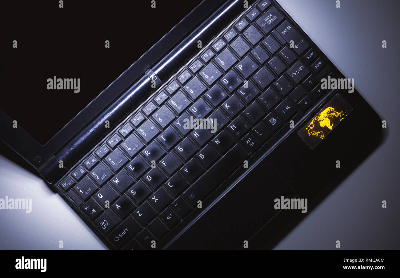 Details of a small, old and dusty laptop on white table Stock Photo - Alamy