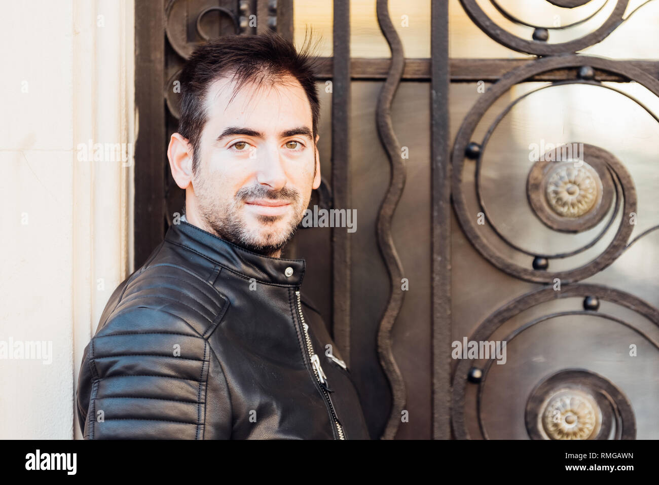 Man, real people, posing in a doorway of a building with a leather ...