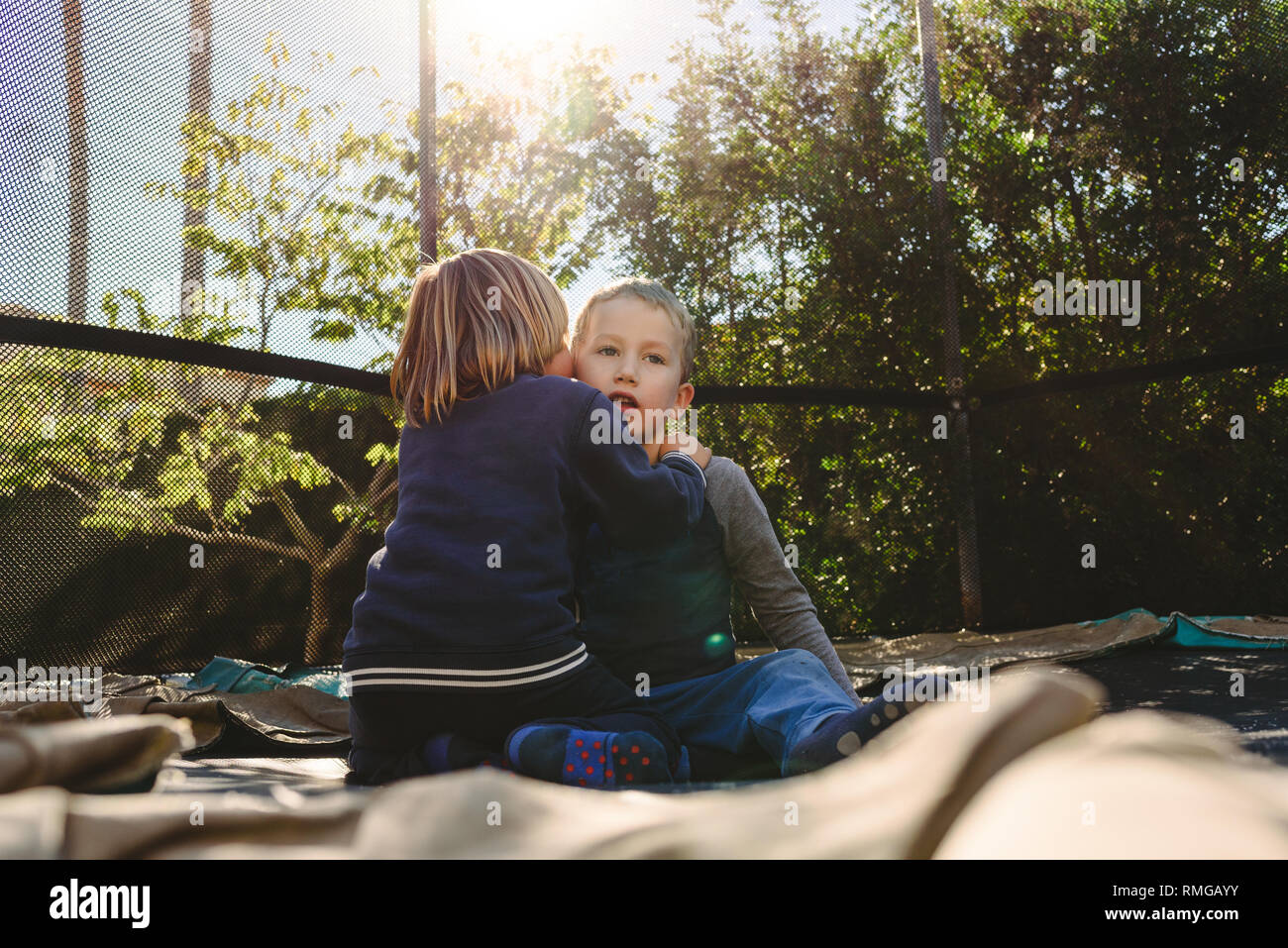 Two children friends accomplices plotting secret games in their spring ...