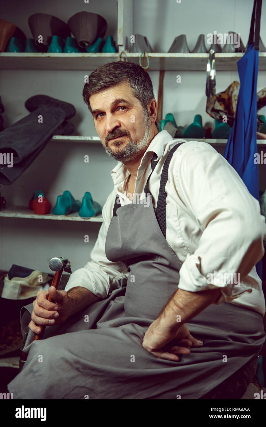 Enjoying process of creation custom made shoes. Workplace of shoe ...