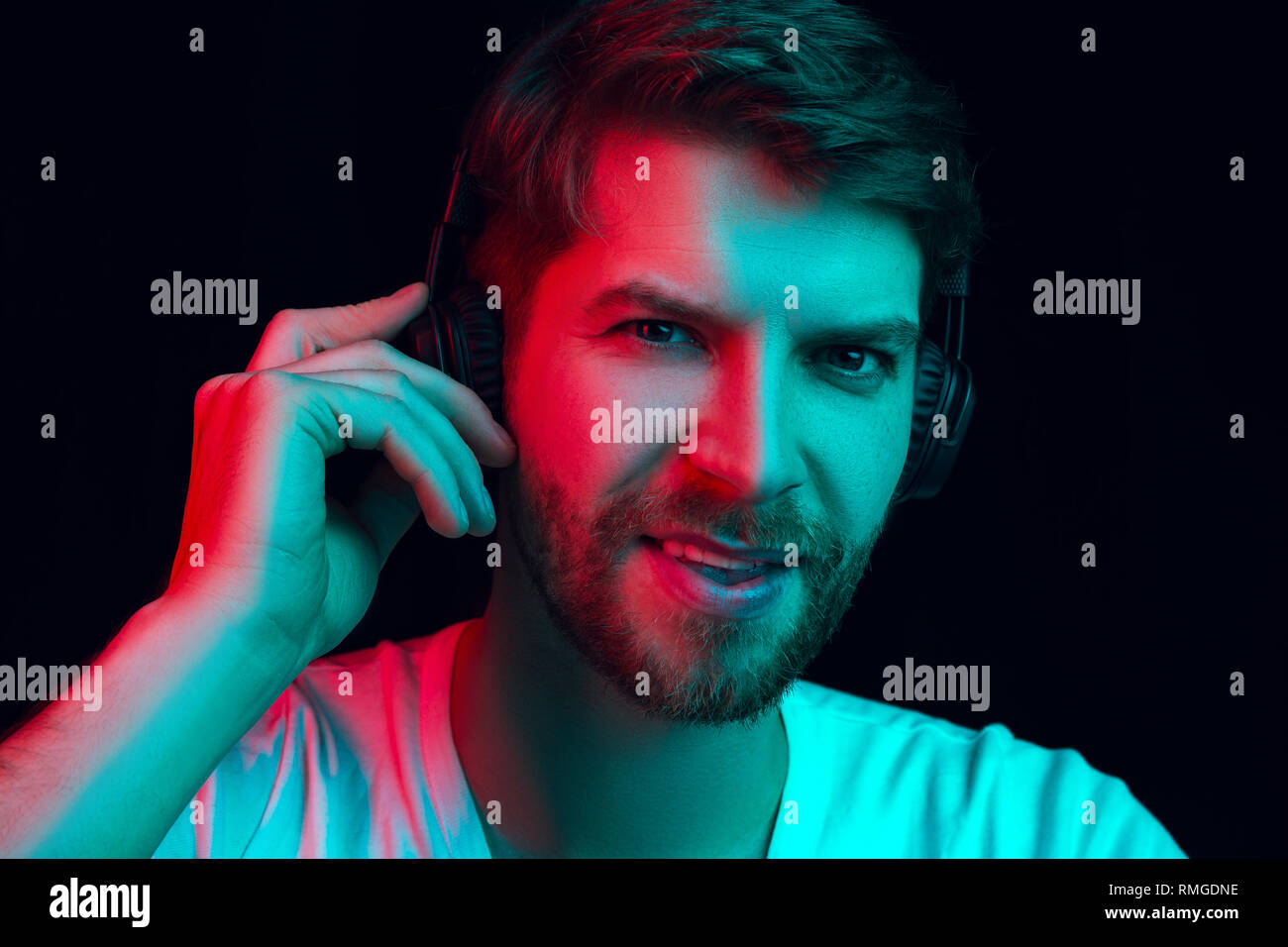 Enjoying his favorite music. Happy young stylish man with headphones ...