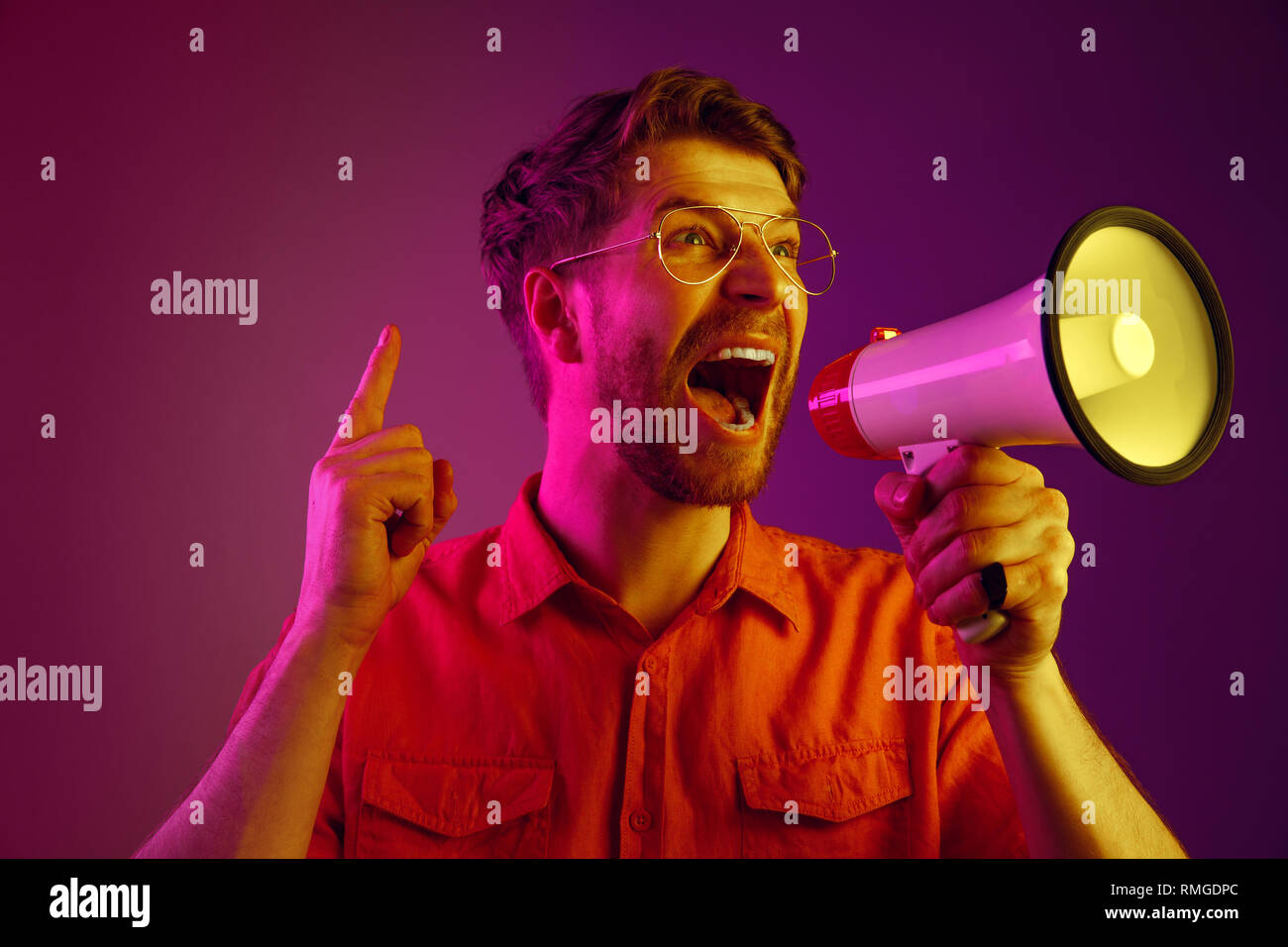 man making announcement with megaphone at gold studio Stock Photo - Alamy