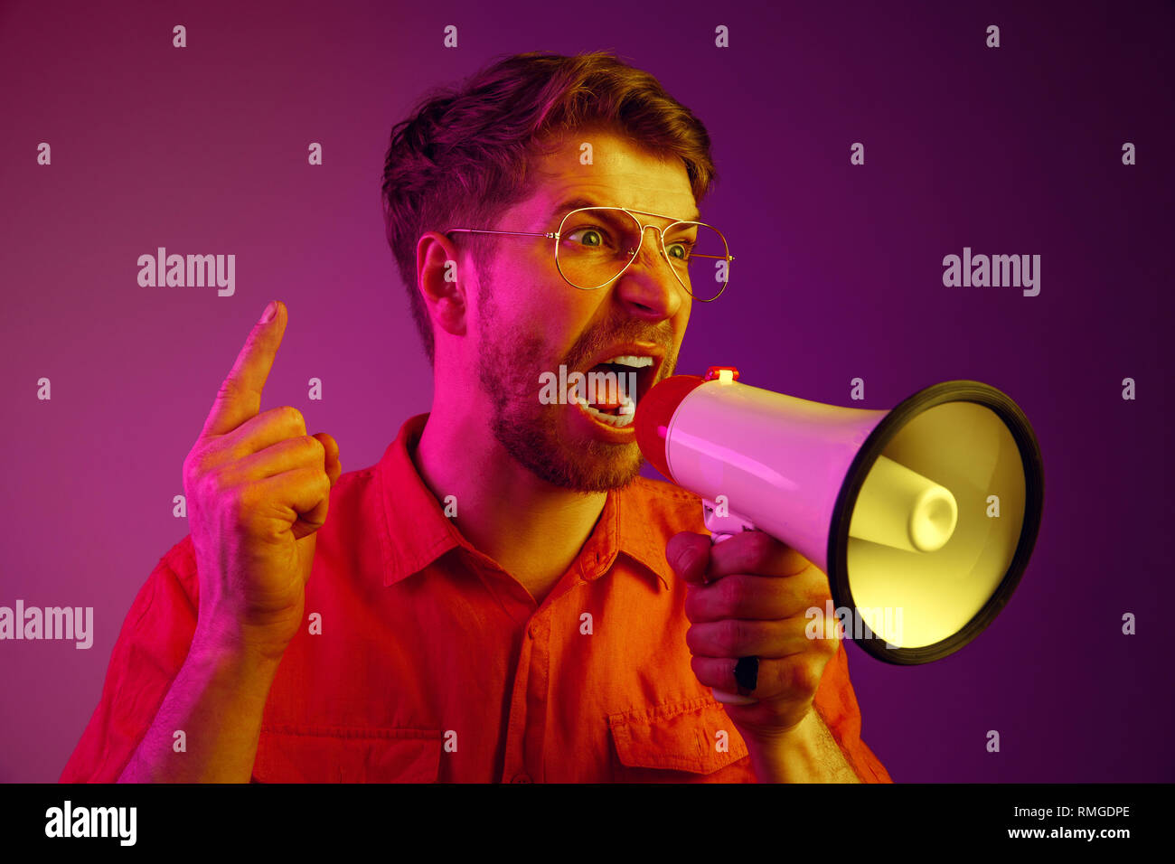 man making announcement with megaphone at gold studio Stock Photo - Alamy