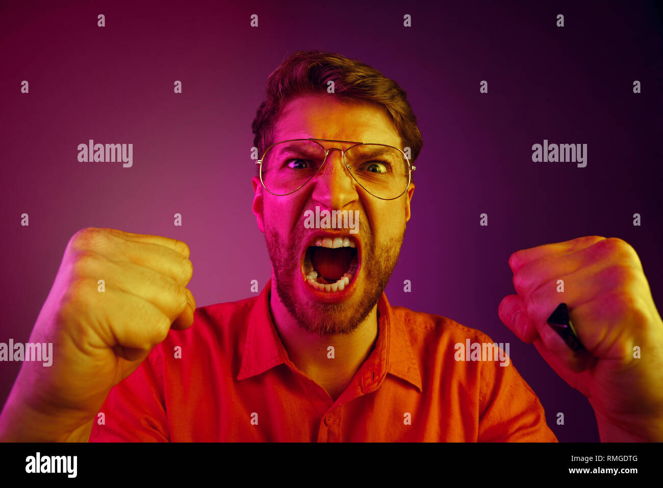 Screaming, hate, rage. Crying emotional angry man screaming on pink ...