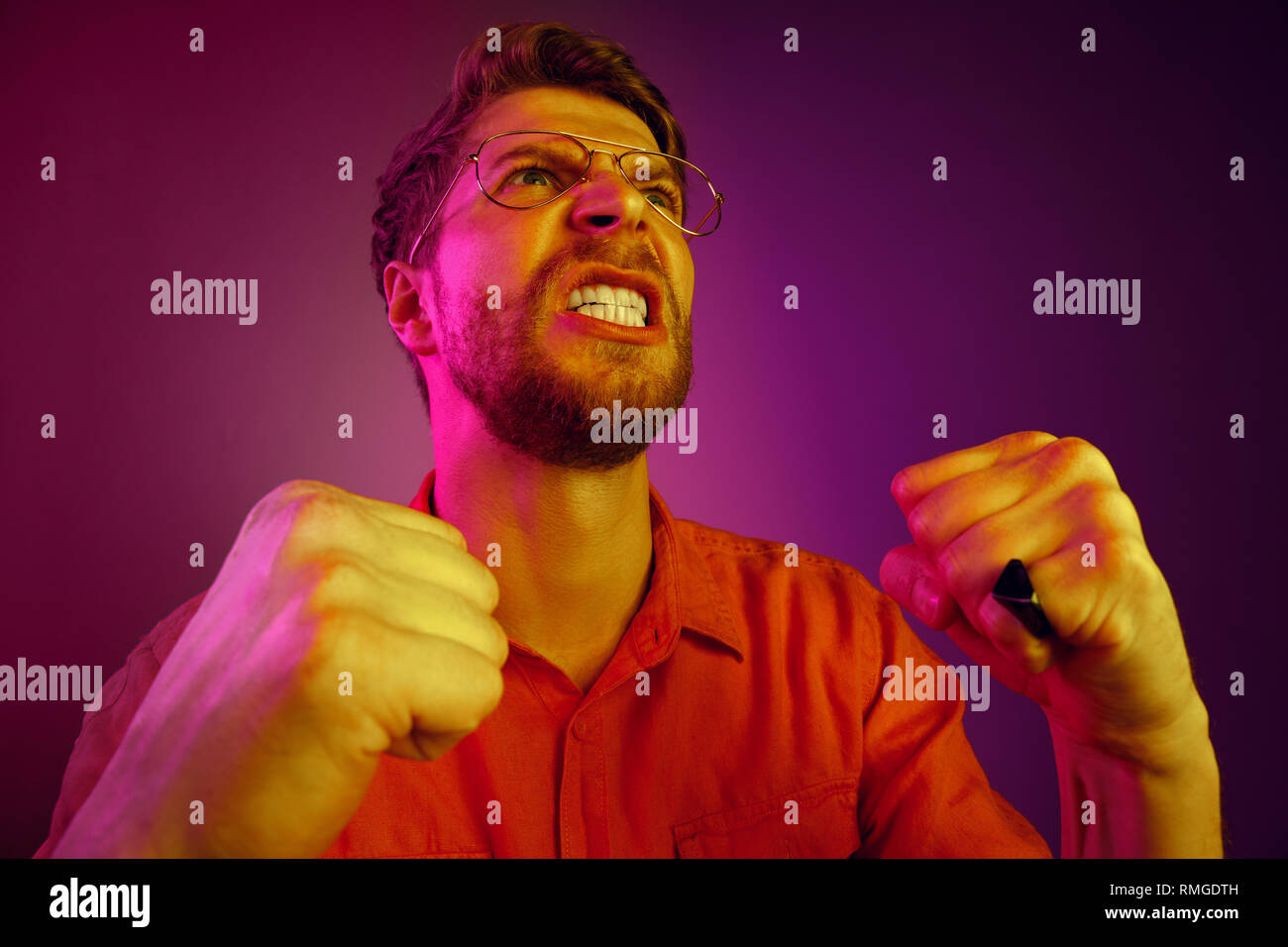 Screaming, hate, rage. Crying emotional angry man screaming on pink ...