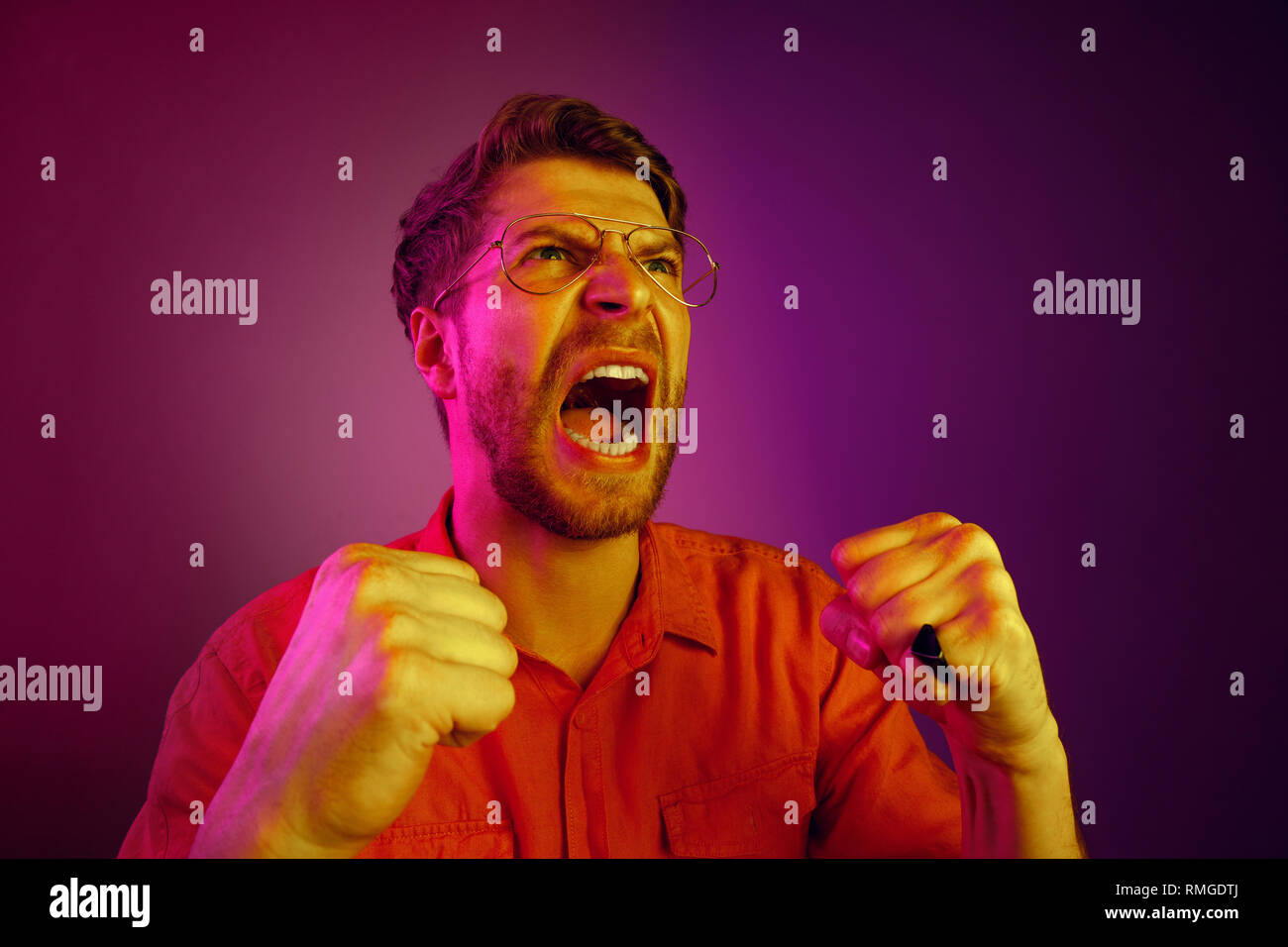 Screaming, hate, rage. Crying emotional angry man screaming on pink ...