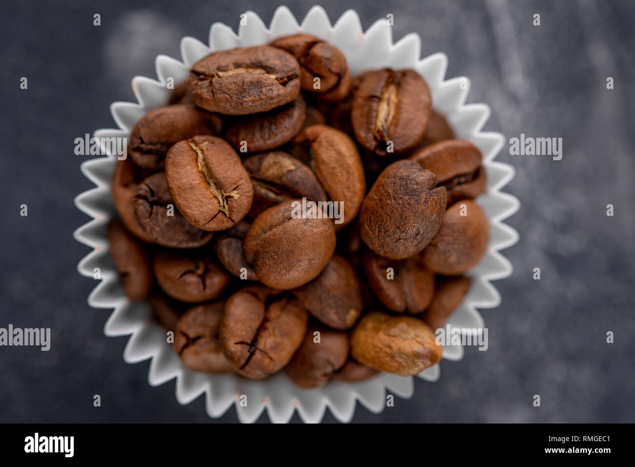 Coffee beans in the package from candy on a dark background. Close-up ...