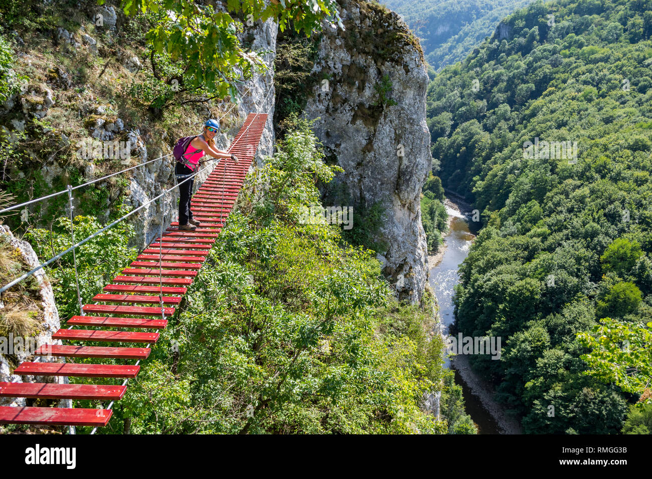 Female tourist on a via ferrata bridge in Vadu Crisului, Padurea ...
