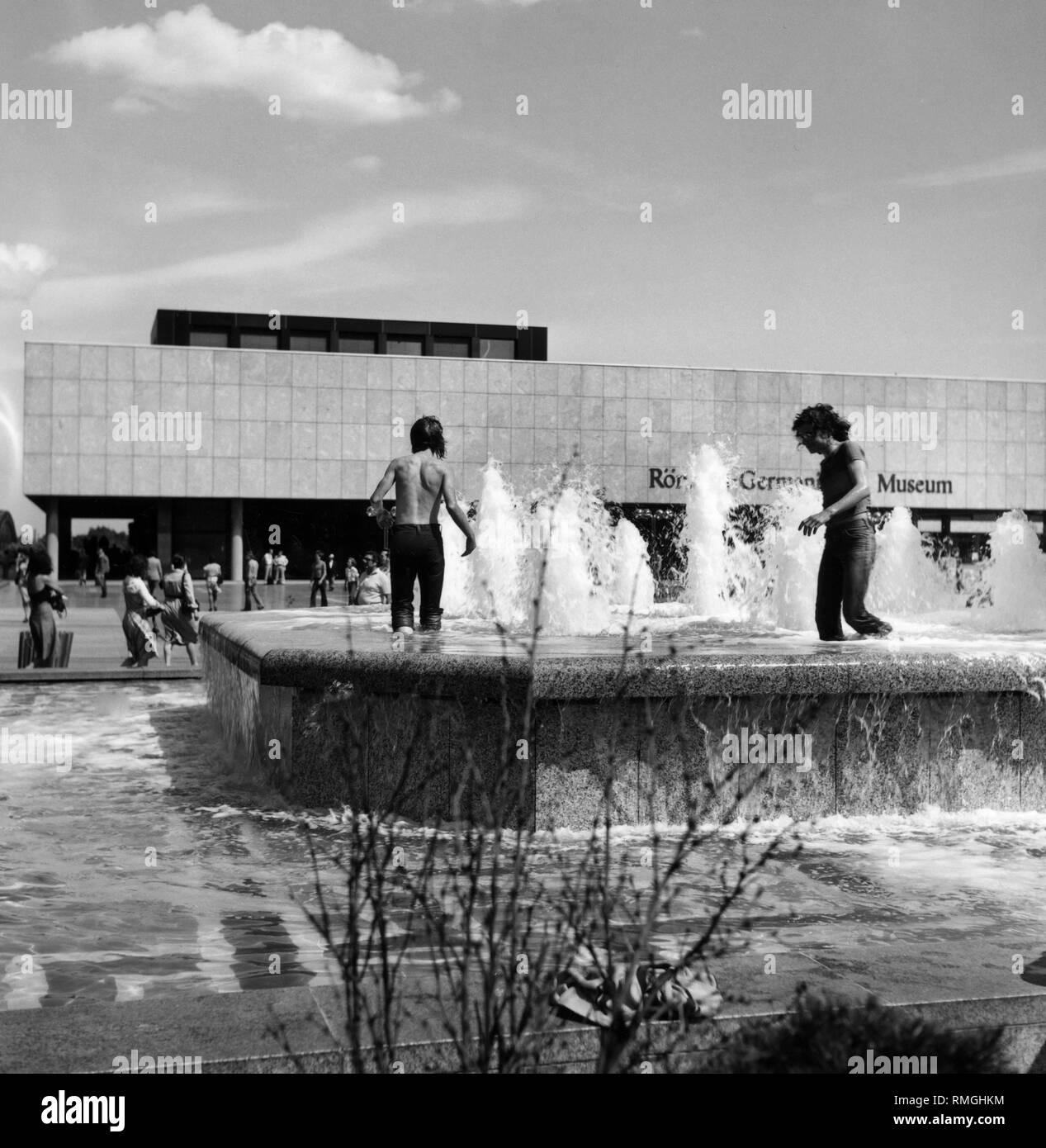 Bathing teenagers in a fountain in summer in front of the Roman ...