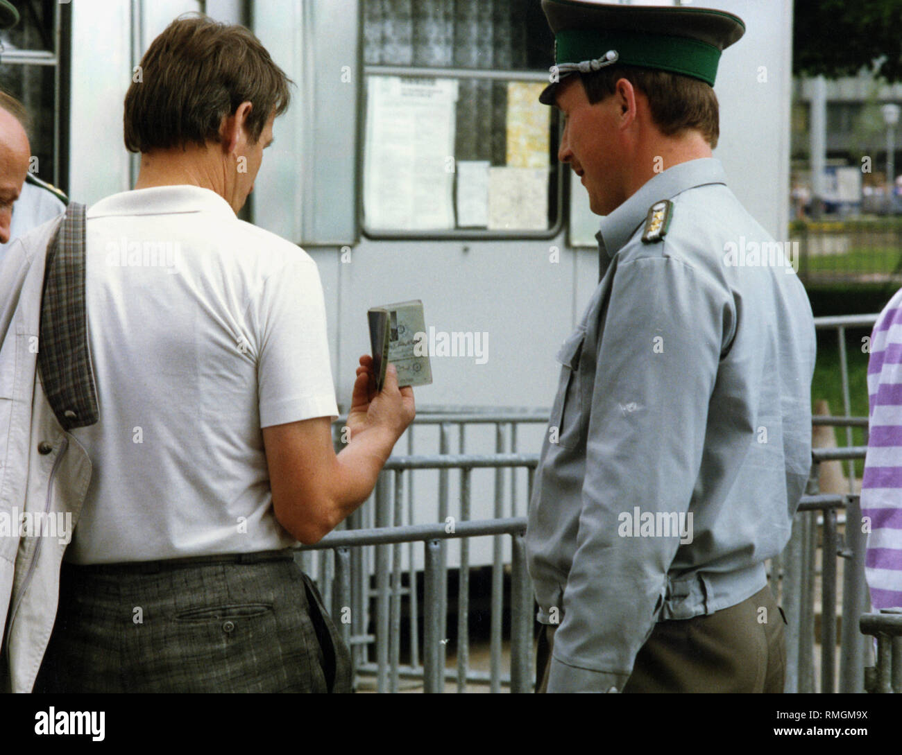 A GDR border official checks the passport of a GDR citizen Stock Photo ...