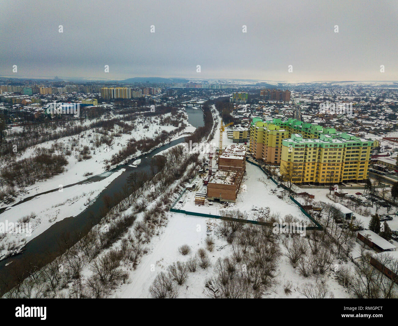 Aerial winter top view of modern developing city suburb area with tall ...