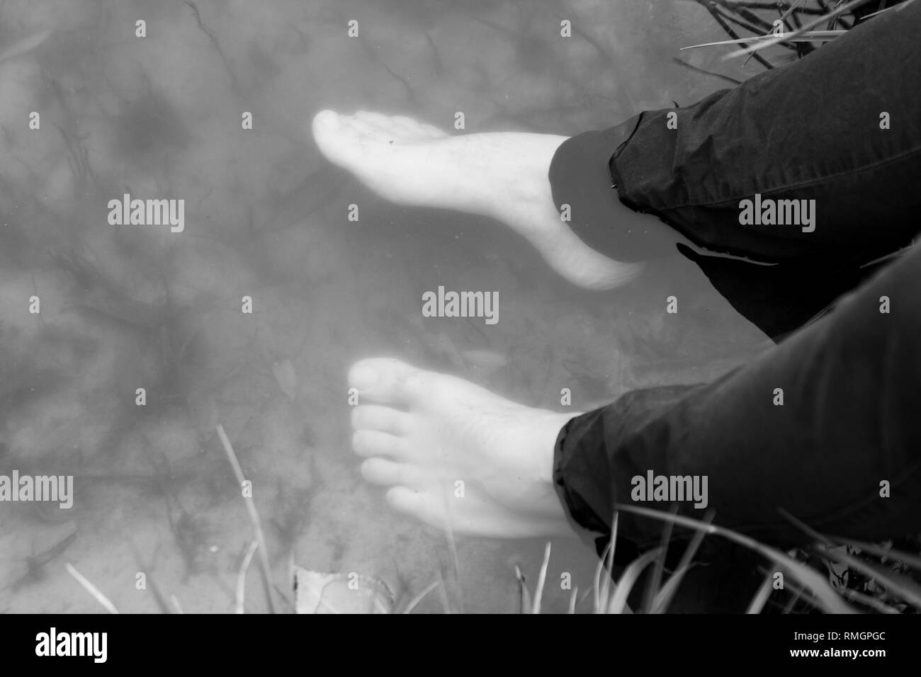 Top view of man leg and feet dip in river, summer relaxing feeling ...