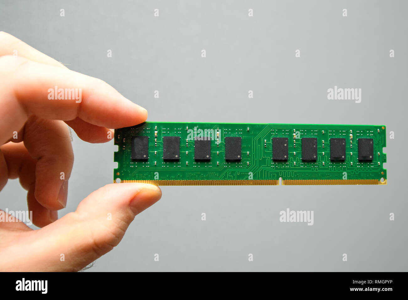 Man holding in hand new powerful RAM manufactured in strict conditions ...