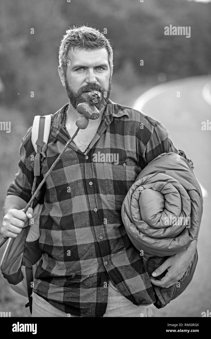 Hitchhiker on the way back to town. Bearded man with rucksack, sleeping ...