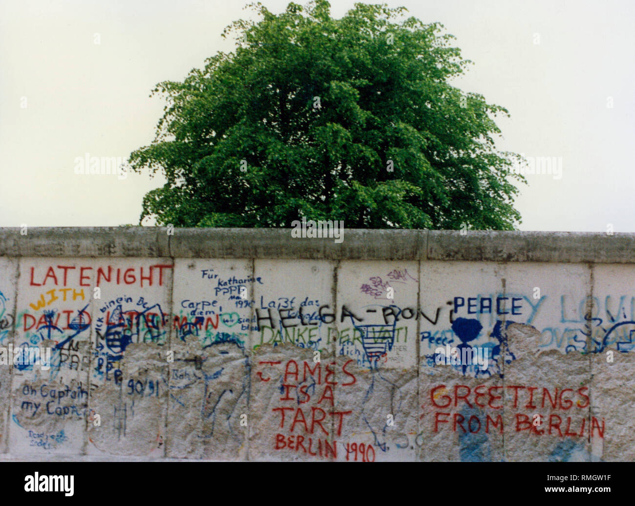 A section of the Berlin Wall with sayings and drawings Stock Photo - Alamy