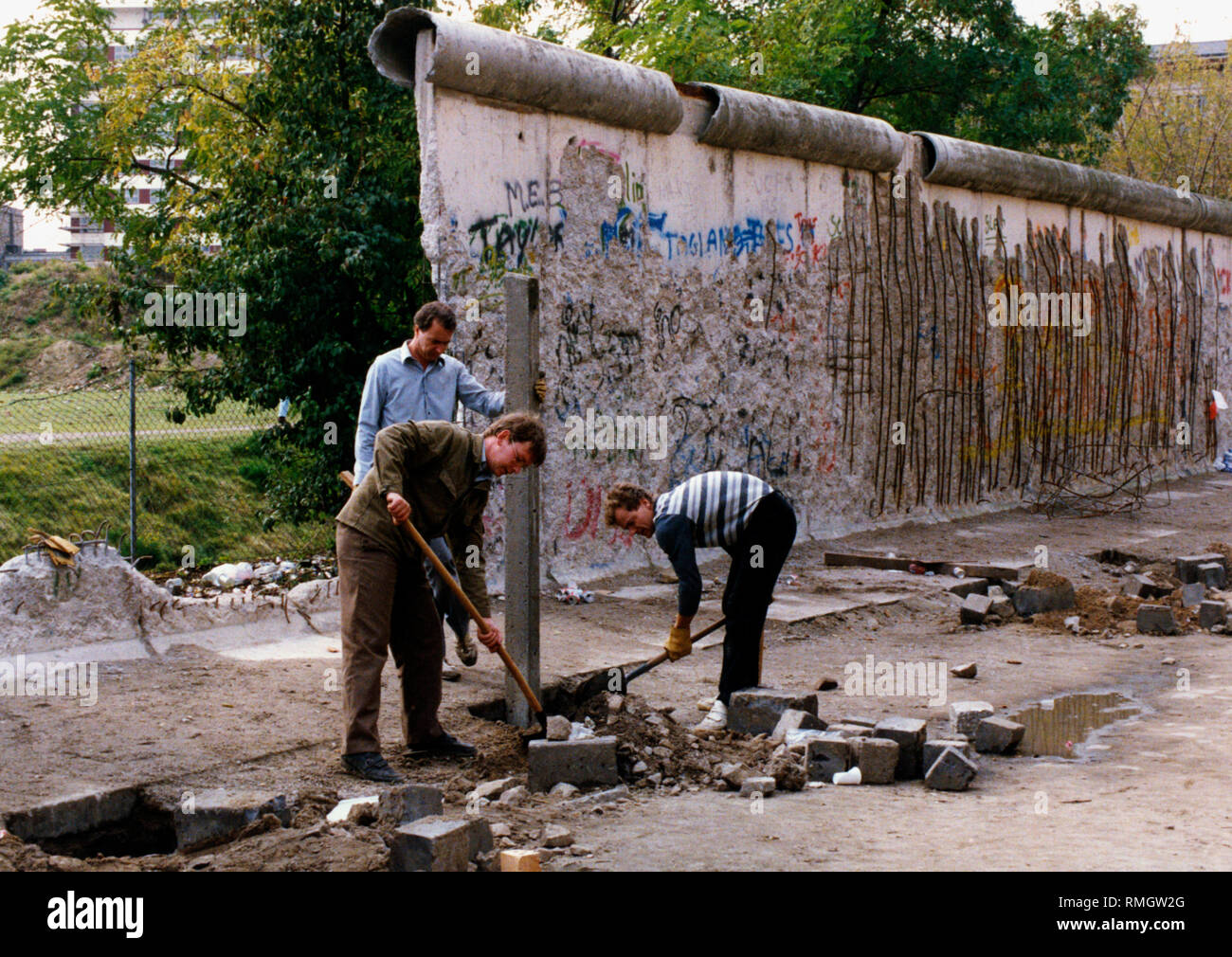 East Berliners working at remnants of the Wall Stock Photo - Alamy