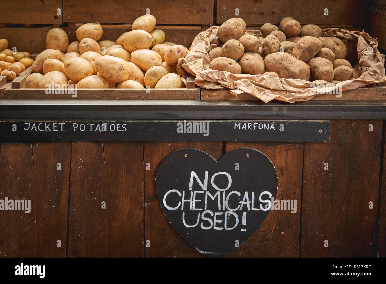 Different varieties of organic potatoes on sale at a stall in a local ...