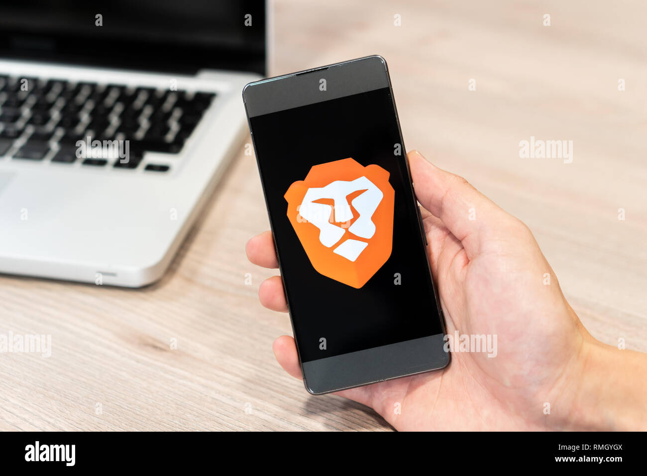 Brave Browser logo displayed on smartphone and computer laptop in ...
