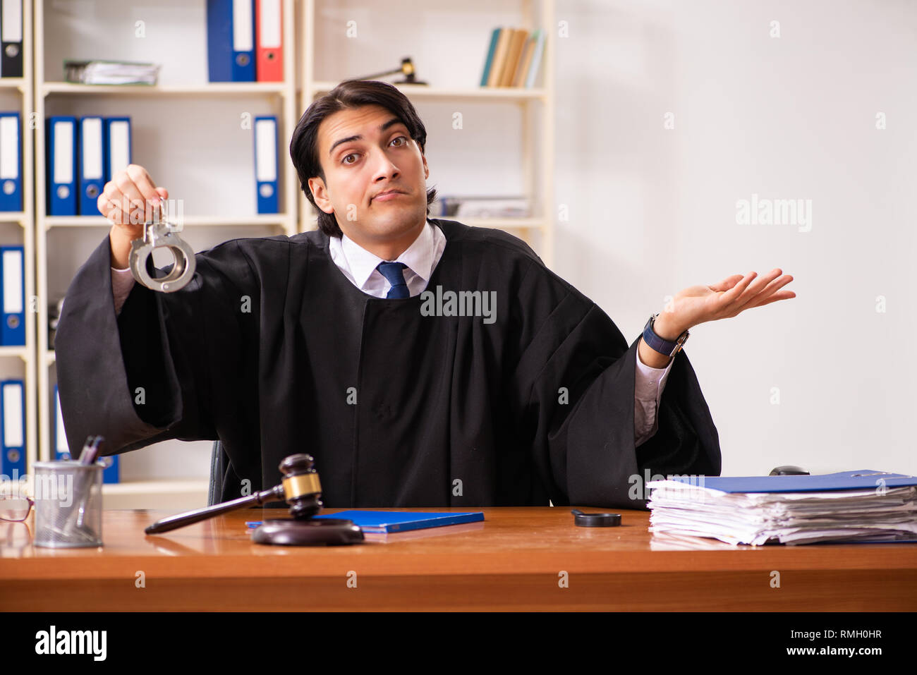 Young handsome judge working in court Stock Photo - Alamy