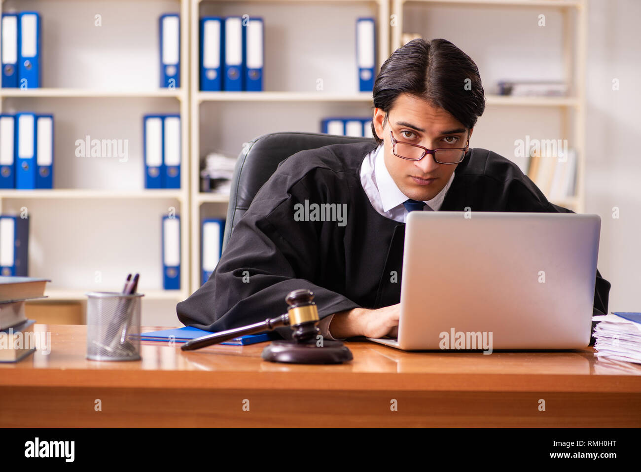 Young handsome judge working in court Stock Photo - Alamy