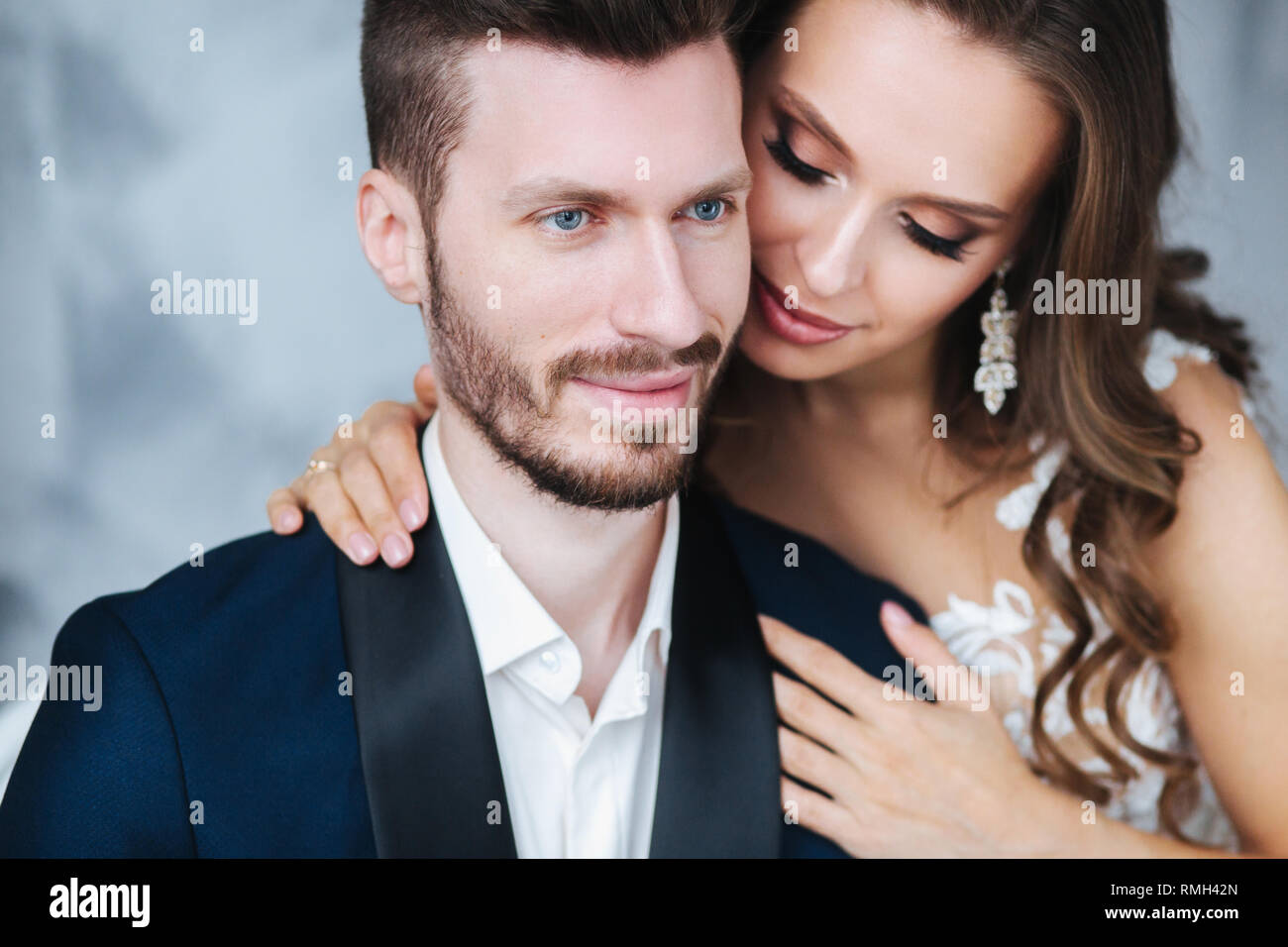 Wedding couple hugging each other indoor.Close-up portrait of wedding ...