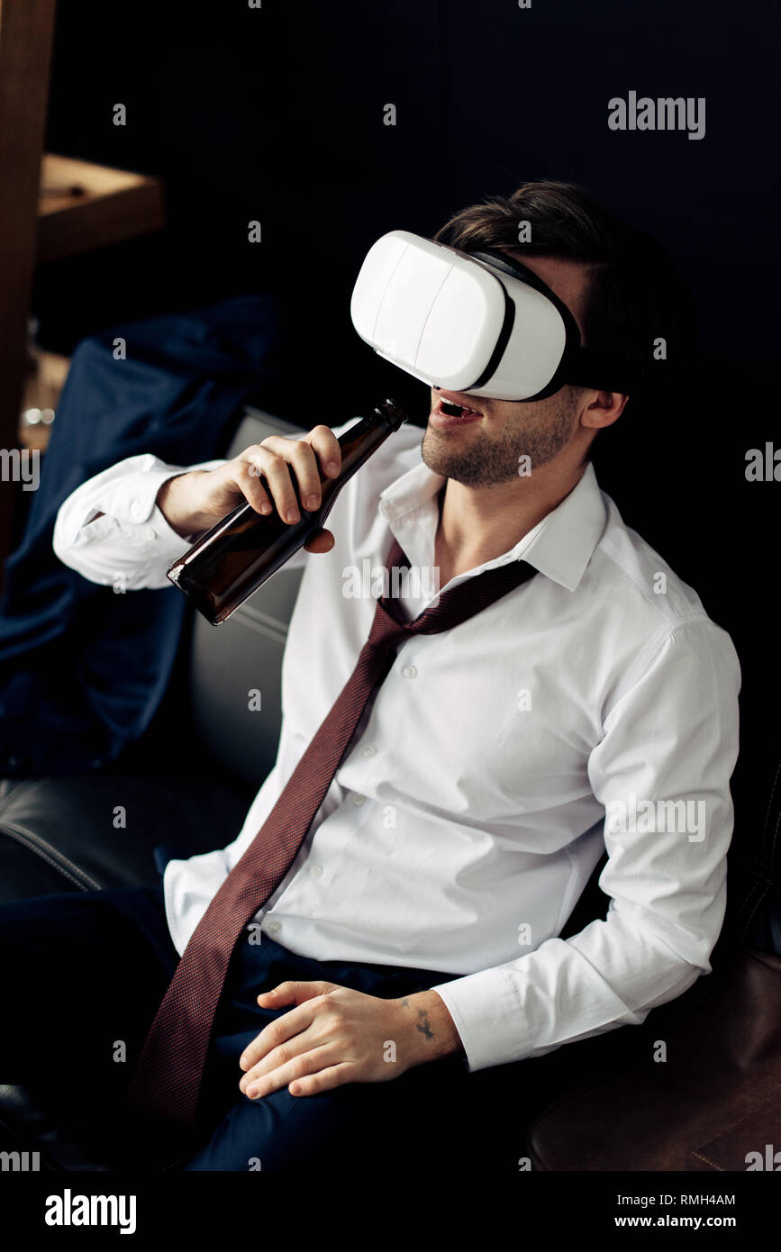 man wearing virtual reality headset and drinking beer Stock Photo - Alamy