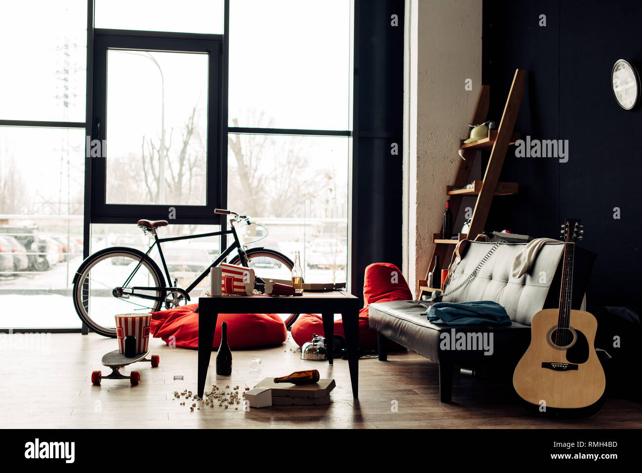 coffee table with food and drinks near sofa and acoustic guitar in ...