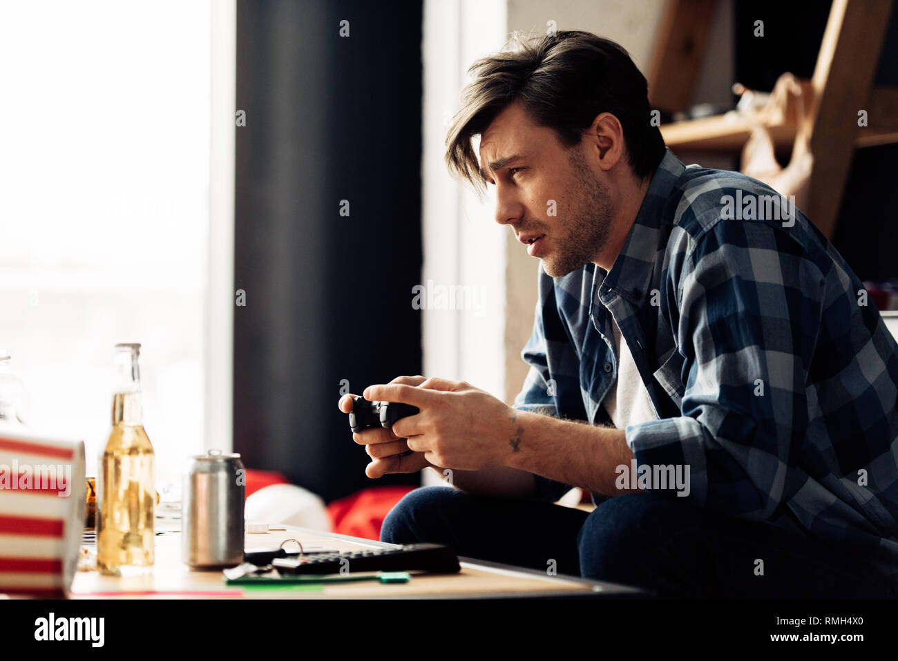 sleepy man playing video game at home Stock Photo - Alamy