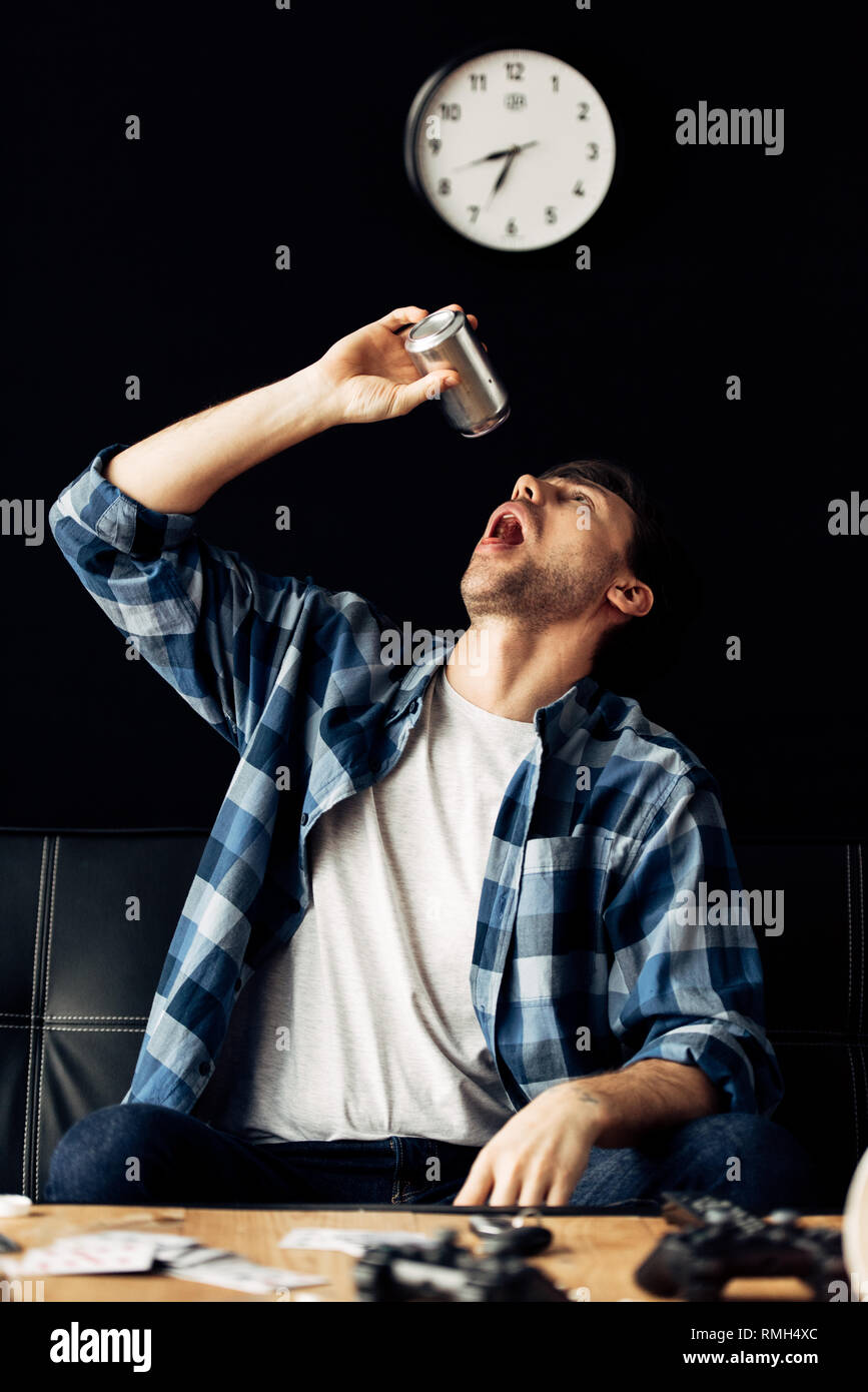 handsome man drinking beer after party at home Stock Photo - Alamy